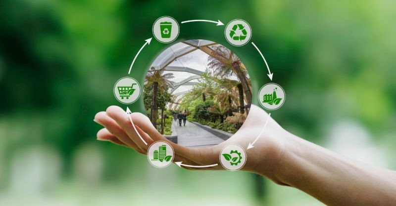 Circular Economy in London: A hand holding a symbol of London’s circular economy, surrounded by ...